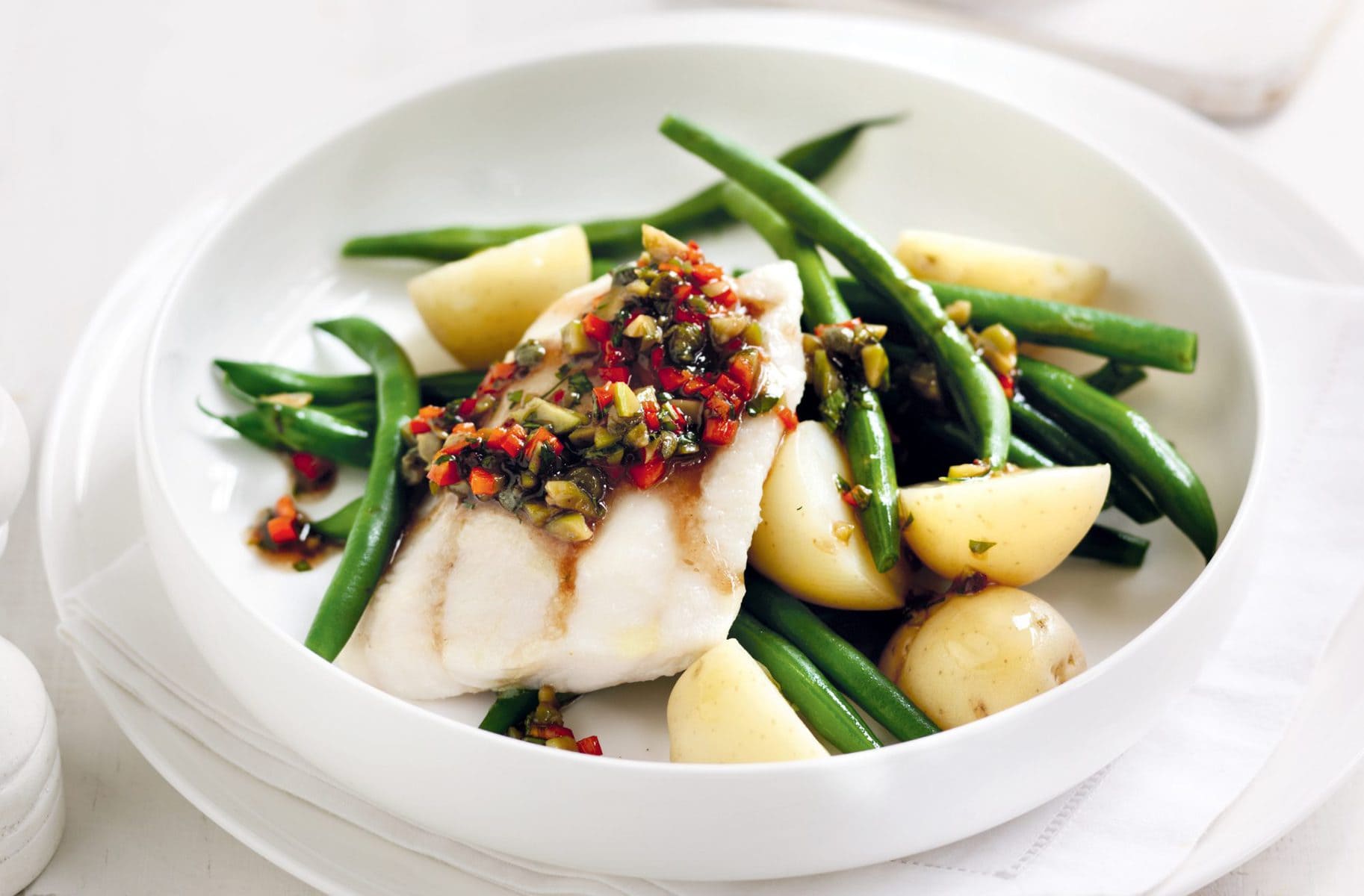 Baked fish with warm Niçoise dressing - Healthy Food Guide